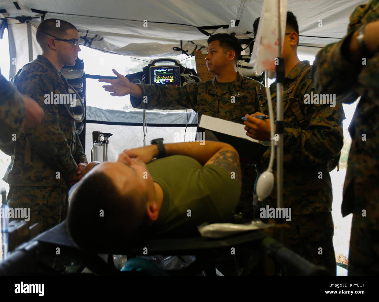 Hospital corpsmen with Charlie Company, 2nd Medical Battalion assess a ...