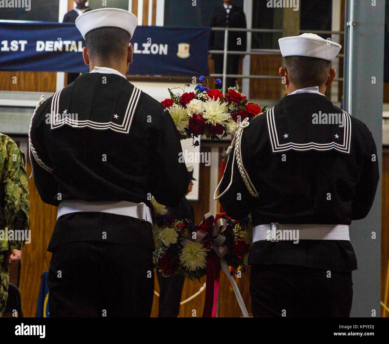 U.S. Navy Sailors as the wreath detail, march on a commemorative wreath ...
