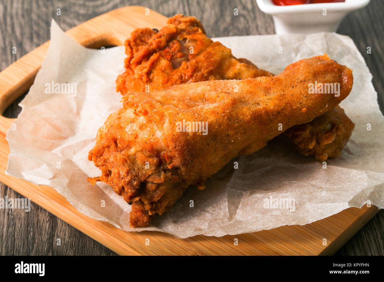 Crispy chicken legs with ketchup Stock Photo - Alamy