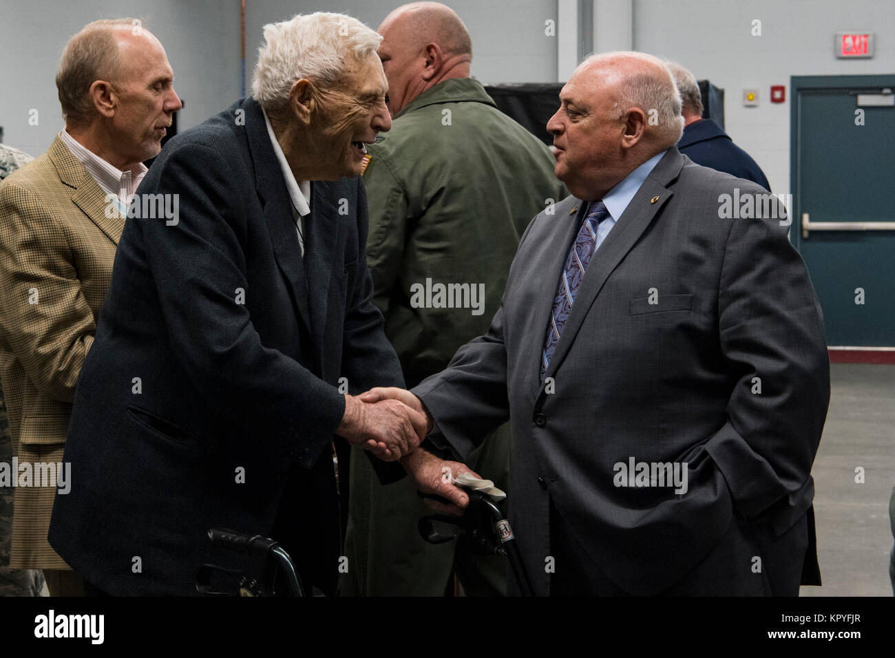 Retired U.S. Air Force Brig. Gen. J. Kemp McLaughlin shakes the hand of ...