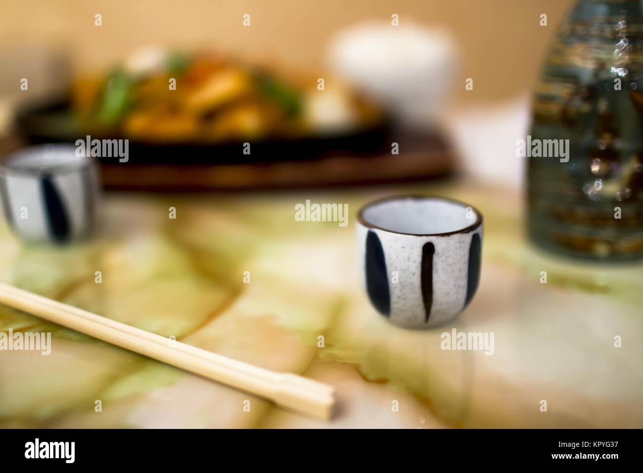 marble table with japanese dinner and saki Stock Photo - Alamy