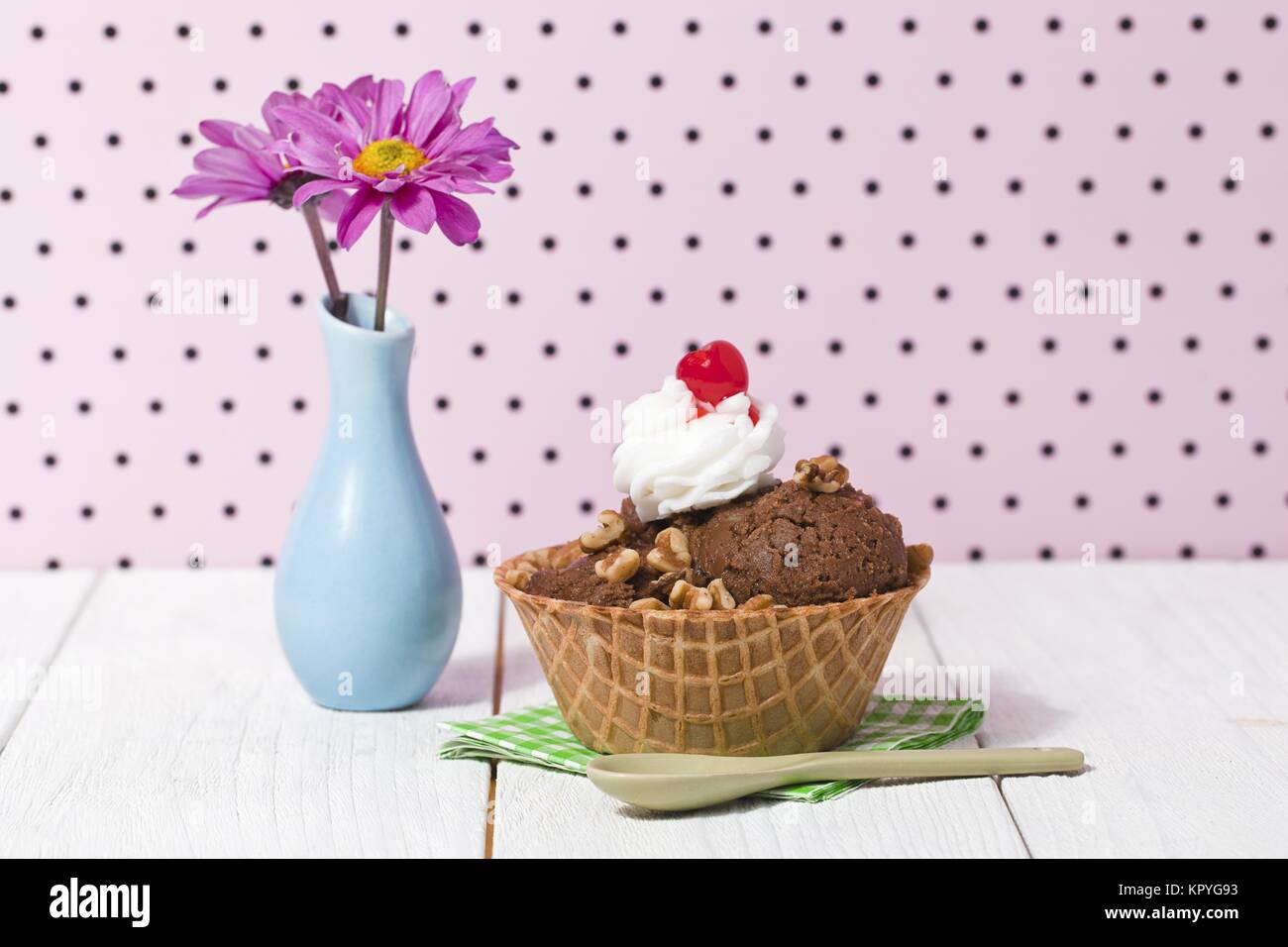 nutty chocolate ice cream in a big cone beside a base Stock Photo - Alamy