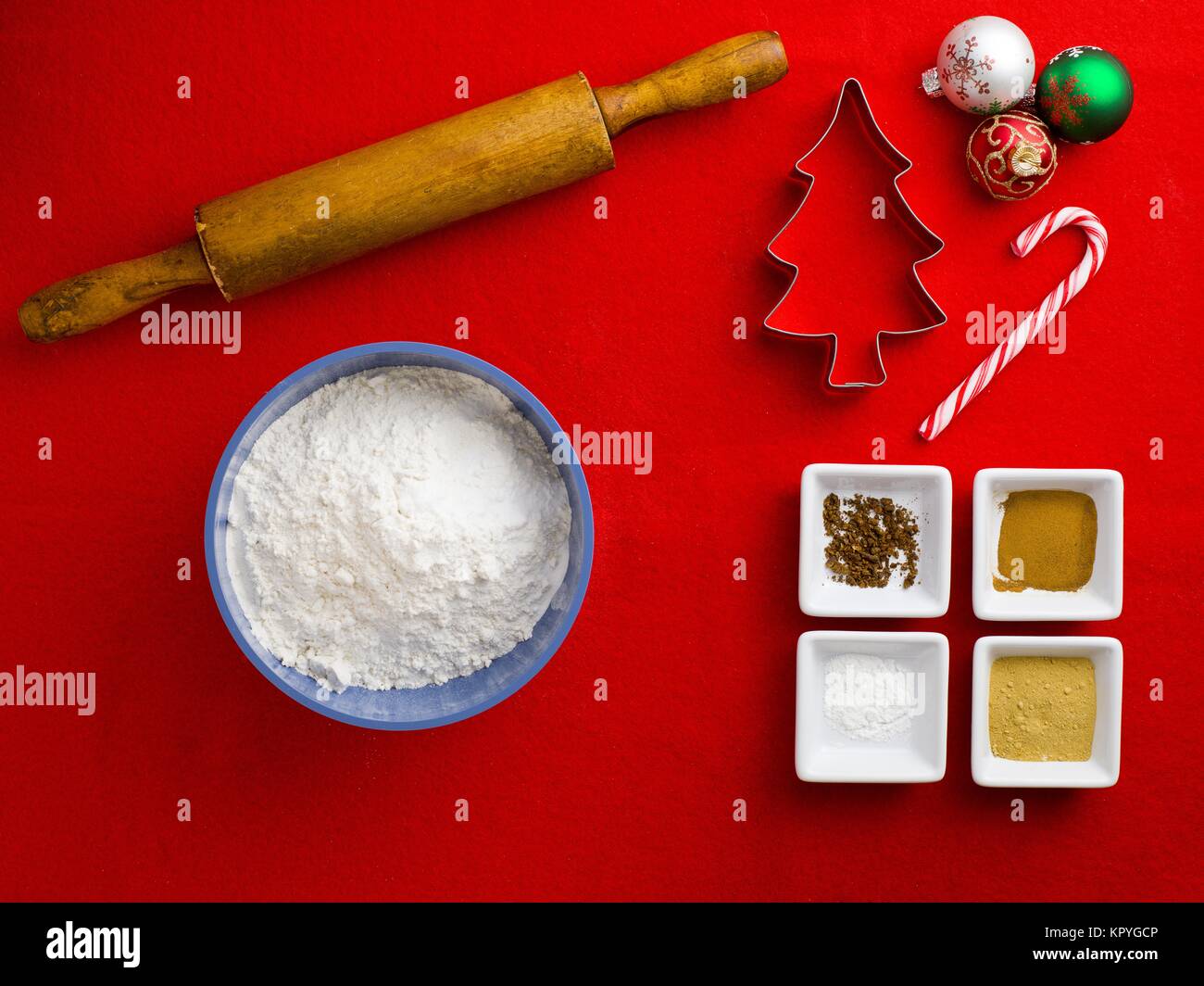 overhead view of rolling pin with candy cane and cookie cutter with ...