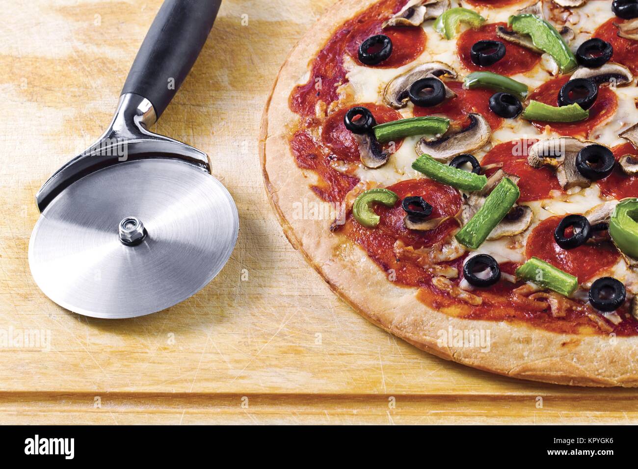 pizza with pizza cutter Stock Photo - Alamy