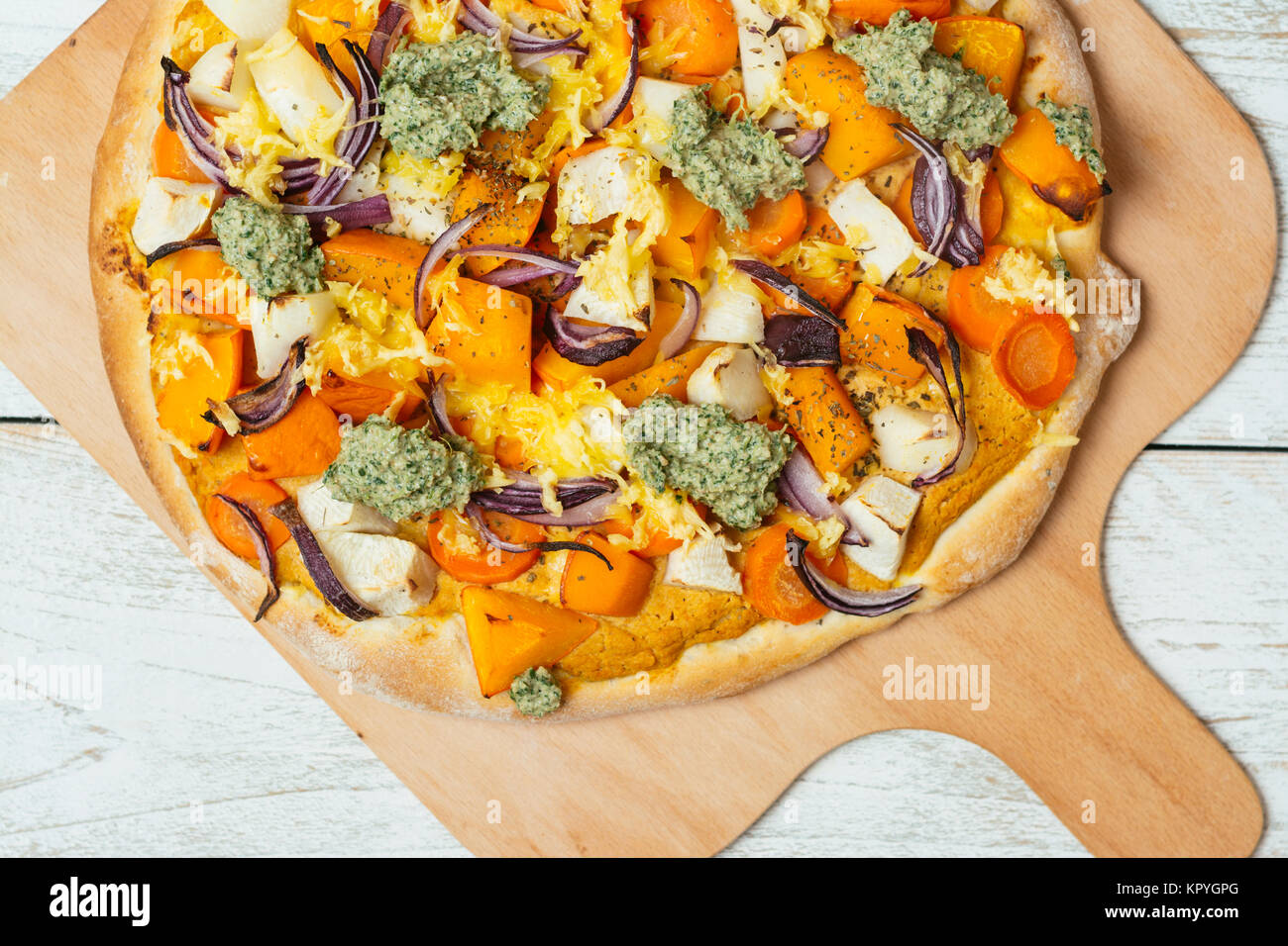 Homemade pizza with winter squash, parsnips, black radish, red onions ...