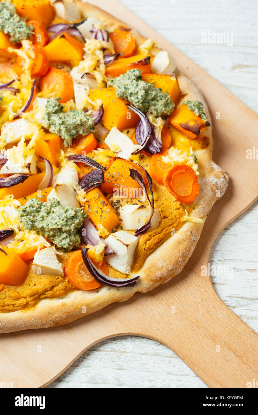 Homemade pizza with winter squash, parsnips, black radish, red onions ...