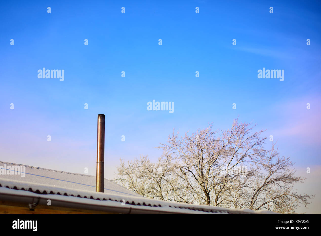 Smoke comes from the chimney of the house. The pipe on the roof ...