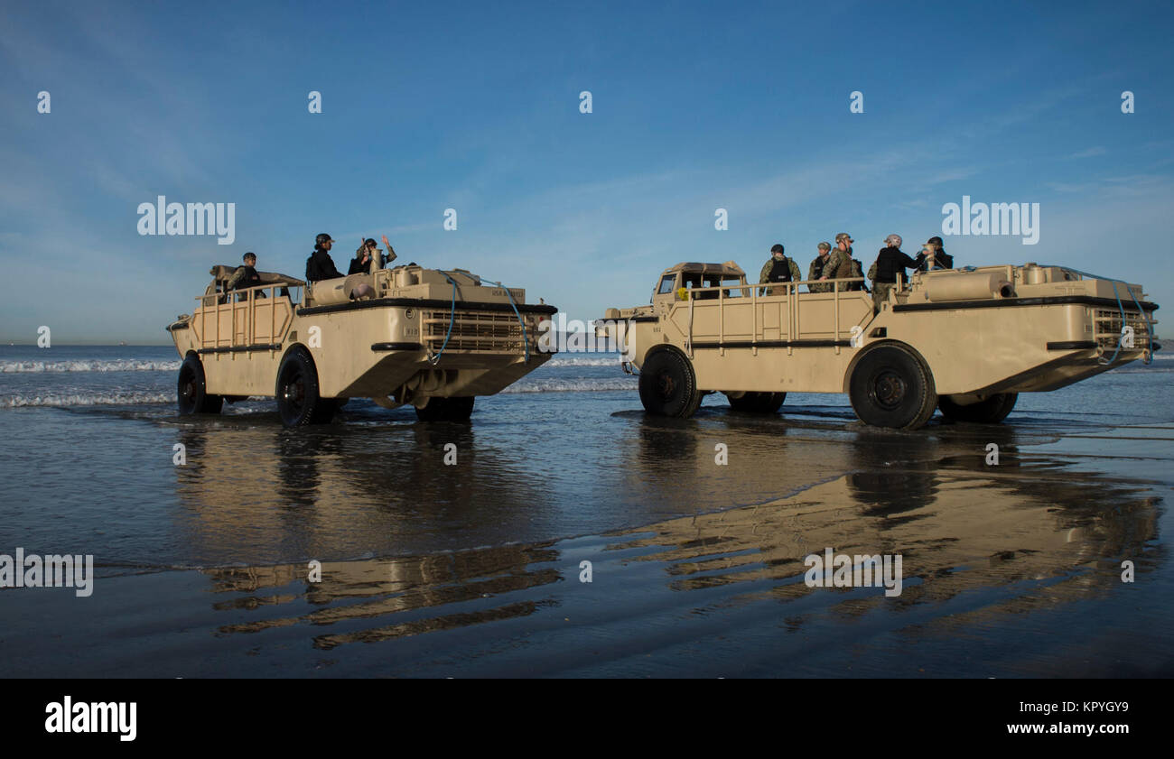 Two Light Amphibious Recovery Craft (LARC-V) ride into the surf during ...