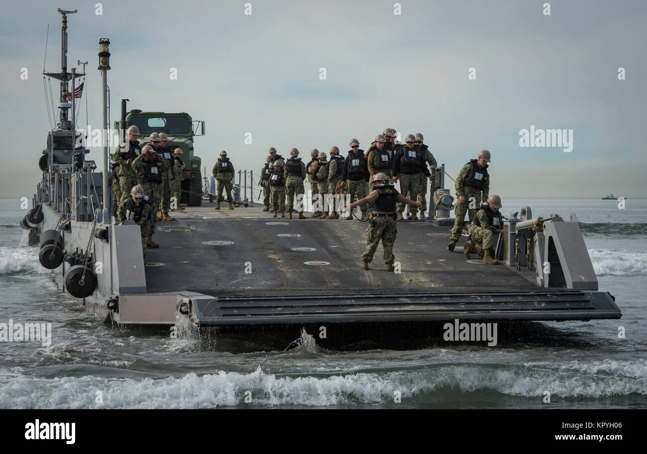 Seabees assigned to Amphibious Construction Battalion One (ACB-1) raise ...