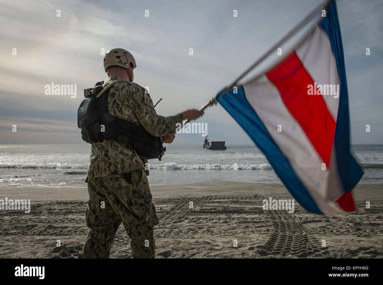 A Sailor assigned to Beachmaster Unit One (BMU-1) signals to a Improved ...