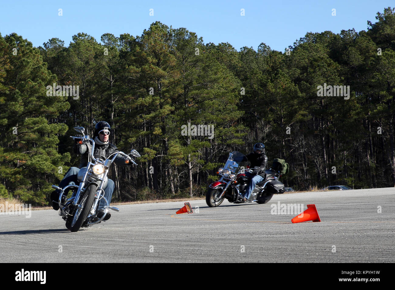 Motorcyclists complete familiarization laps around a training track ...