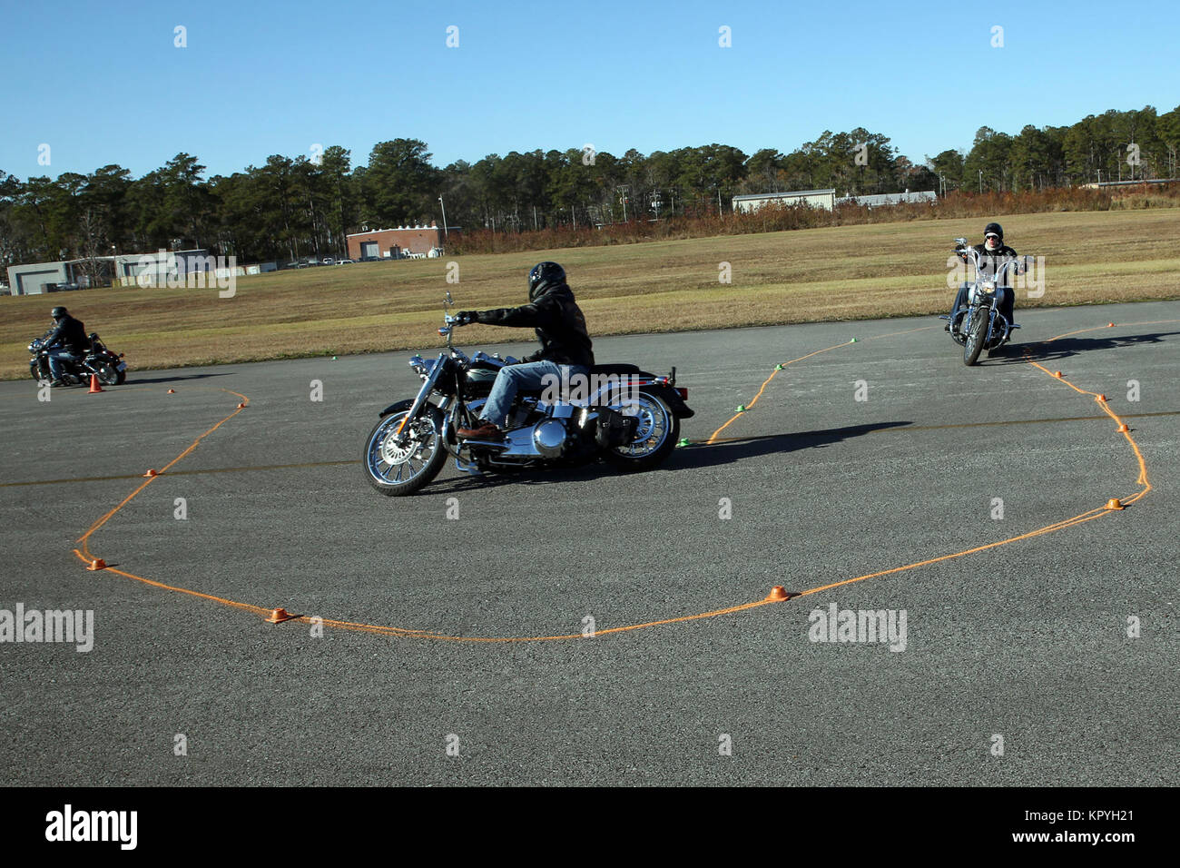 Motorcycle riders navigate tight turns on a practice track during a ...