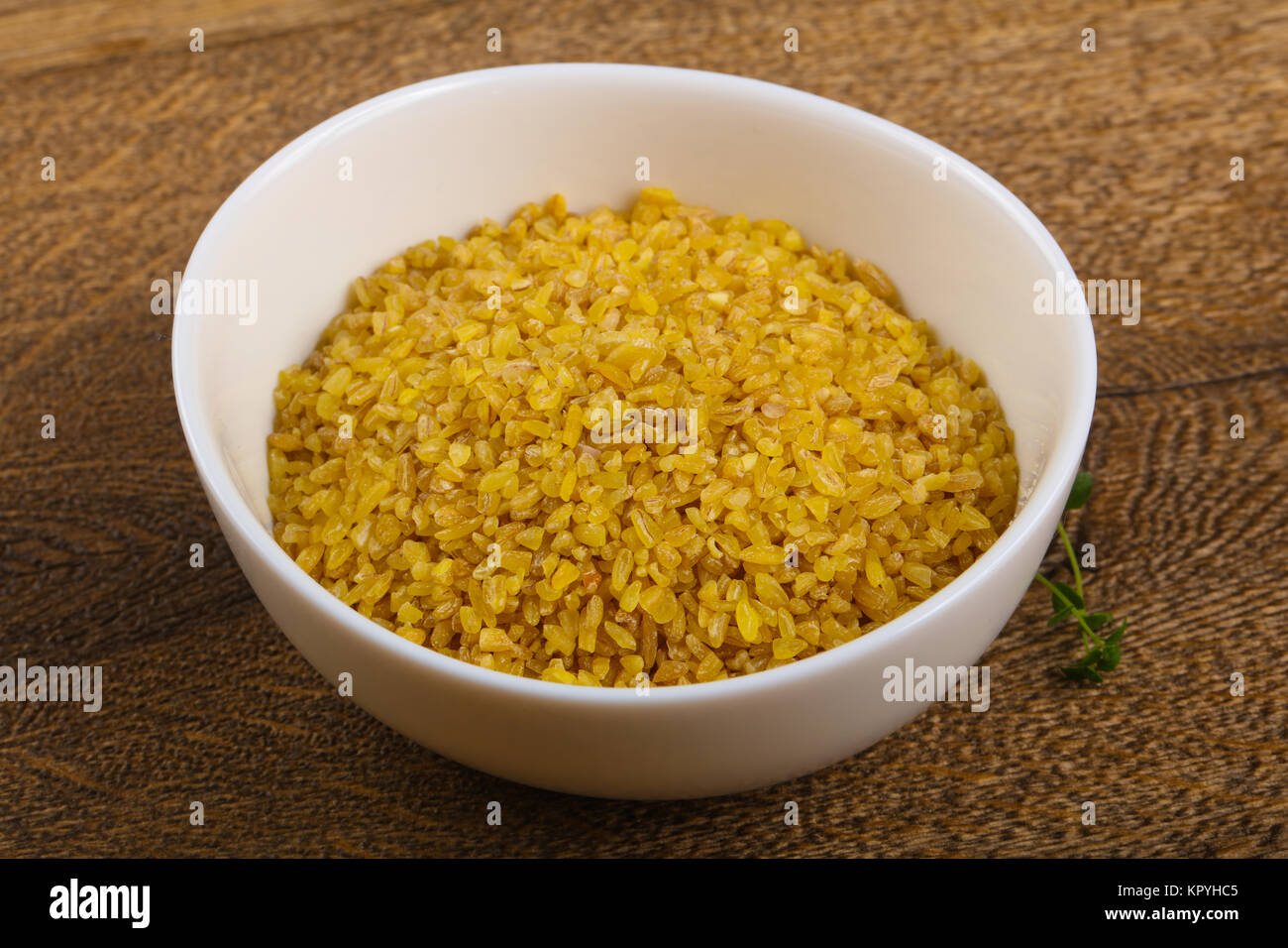 Raw bulgur heap in the bowl ready for cooking Stock Photo - Alamy