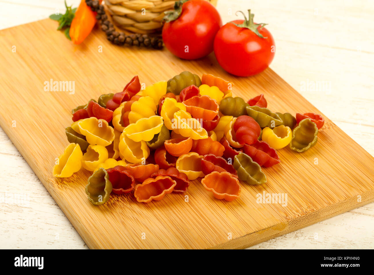 Raw pasta ready for cooking over the wooden background Stock Photo - Alamy