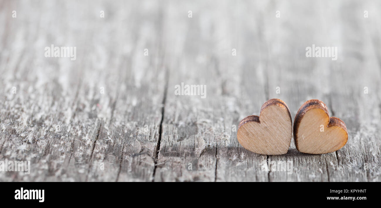 Two small wooden hearts on old cracked wood background Stock Photo - Alamy