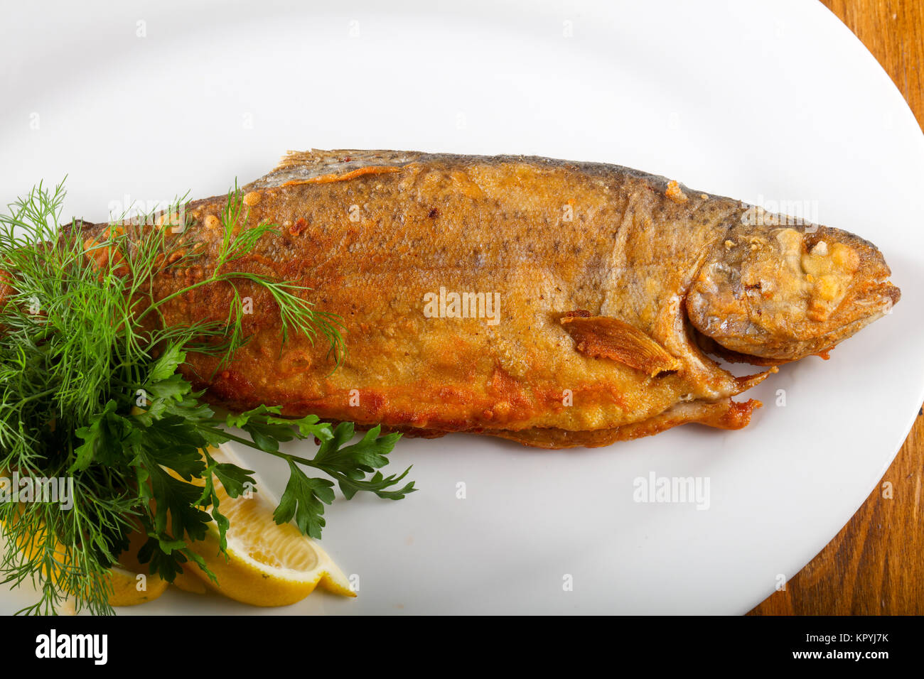 Roasted trout served lemon and herbs Stock Photo - Alamy