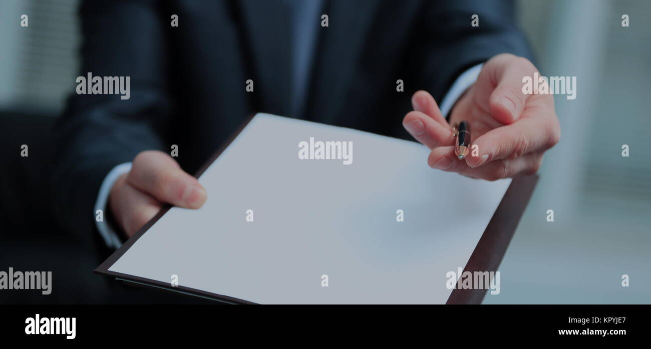 Businessman giving pen for your signature on clipboard Stock Photo - Alamy
