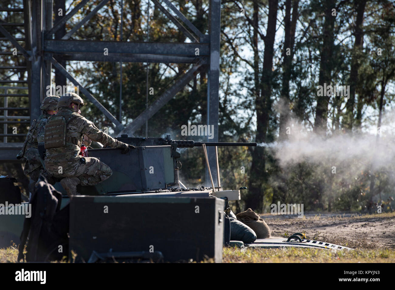 An Airman from the 823d Base Defense Squadron, fires a .50 Caliber M2 ...