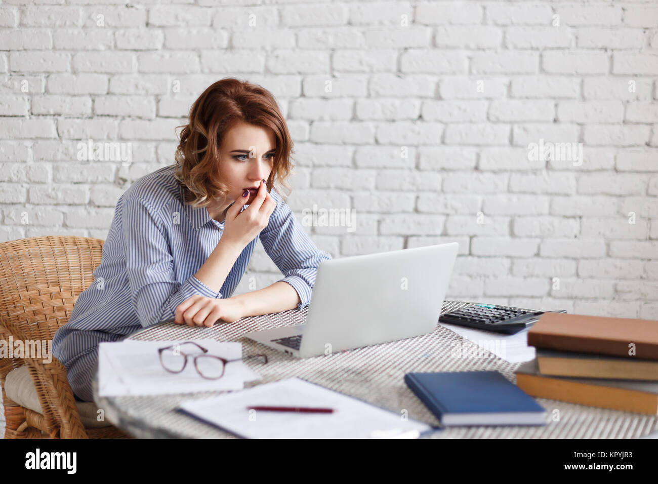 Surprised businesswoman looking at laptop pc, astonished woman with ...