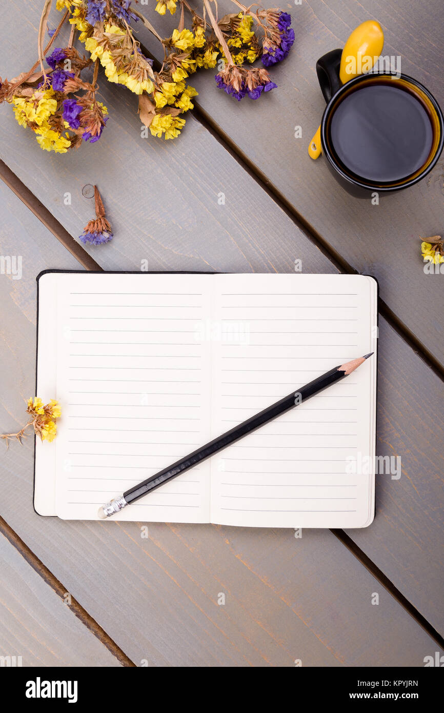 Coffee cup and notebook on wooden table. Good morning Stock Photo - Alamy