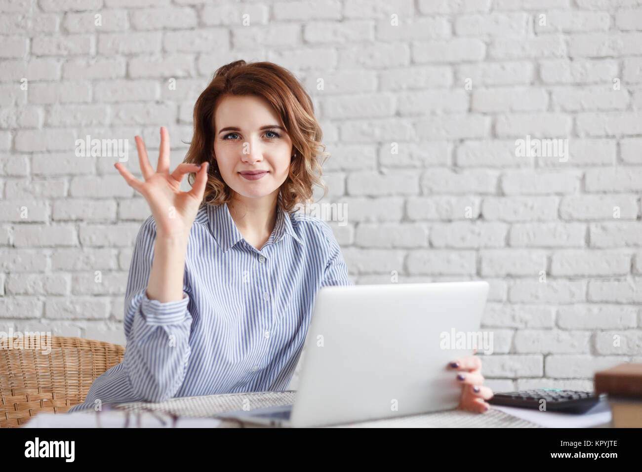 Business woman working on laptop and shoving ok Stock Photo - Alamy