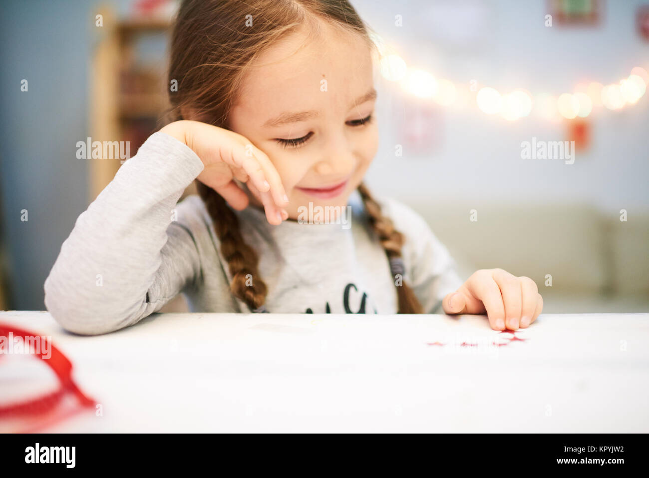 Smiling Little Girl Wrapped up in Handicraft Stock Photo - Alamy