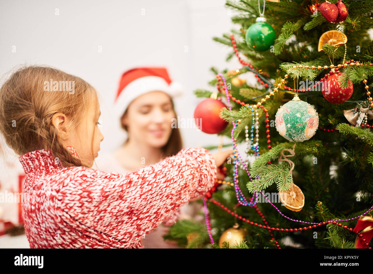 Adorable Little Girl Decorating Christmas Tree Stock Photo - Alamy