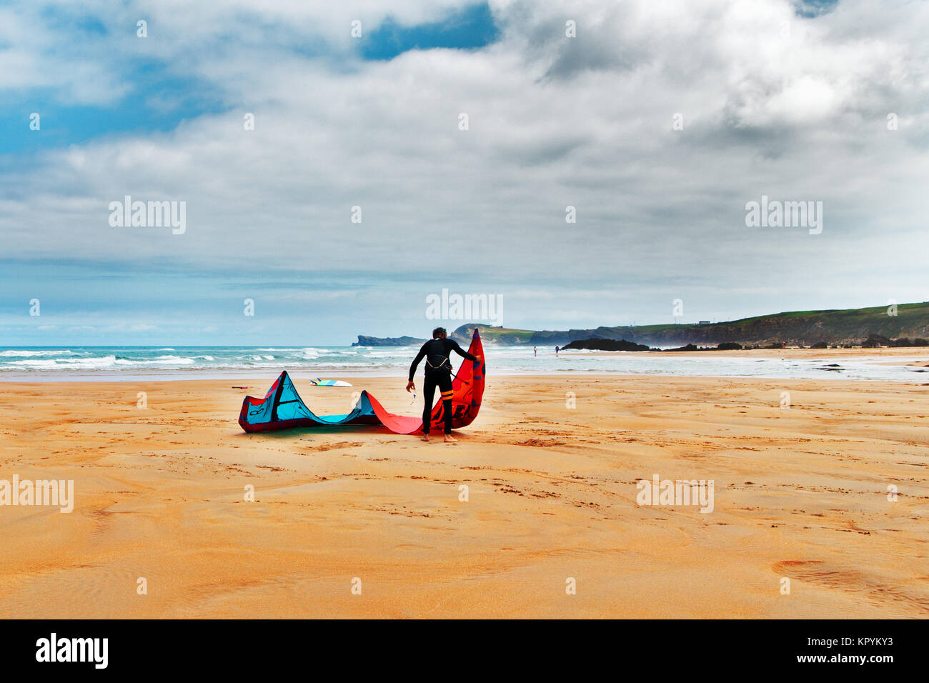 The athlete with windsurfing on the sandy beach. The windsurfer ...