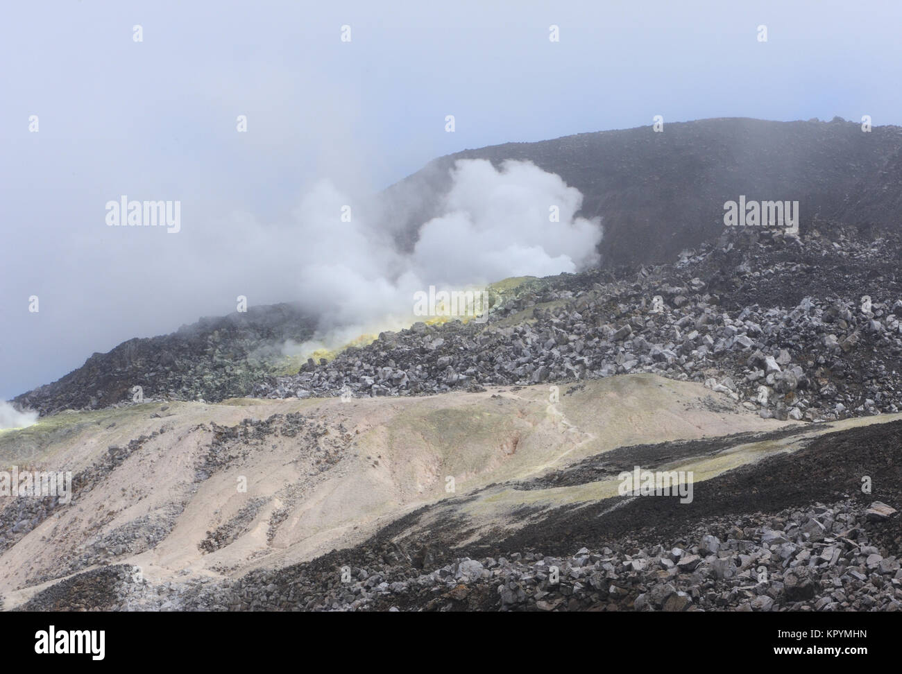 Black lava rocks and clouds of sulphuric acid laden steam billowing ...
