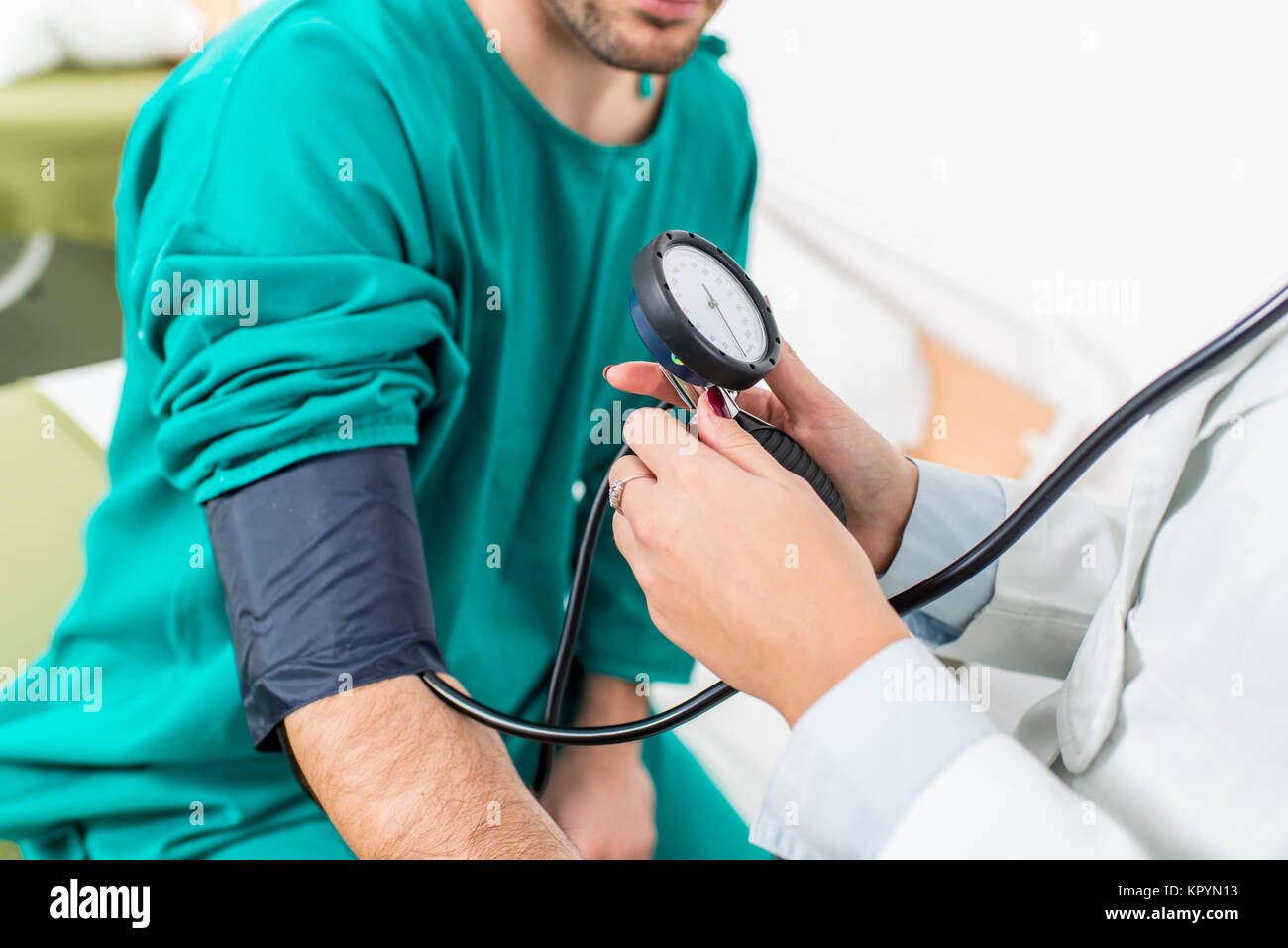 Female doctor checking blood pressure of a patient at clinic Stock ...