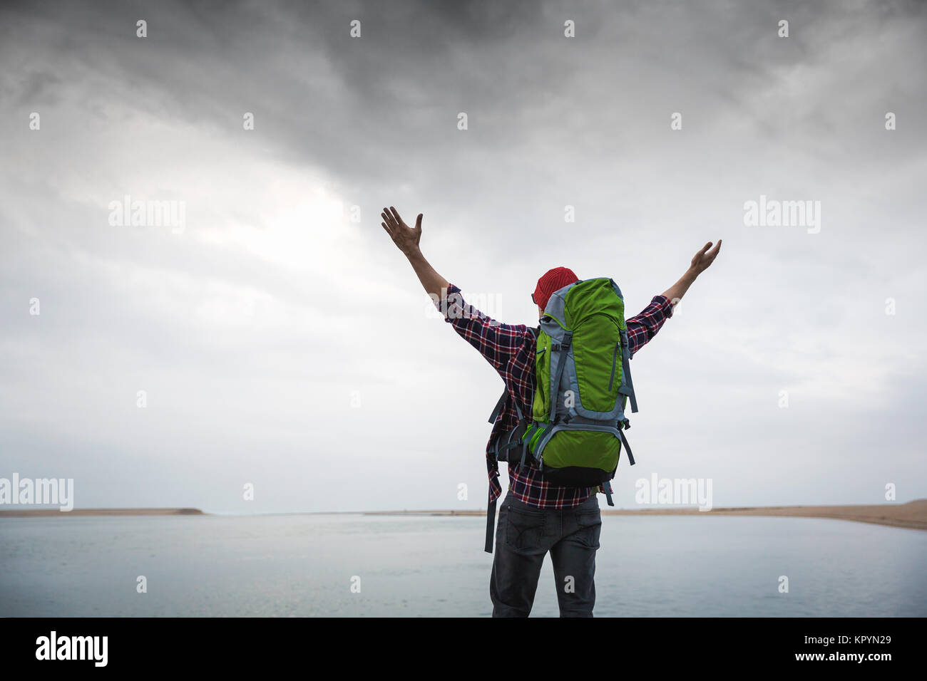 TraveMan Traveling Backpack with arms raised feeling the gratitude ...