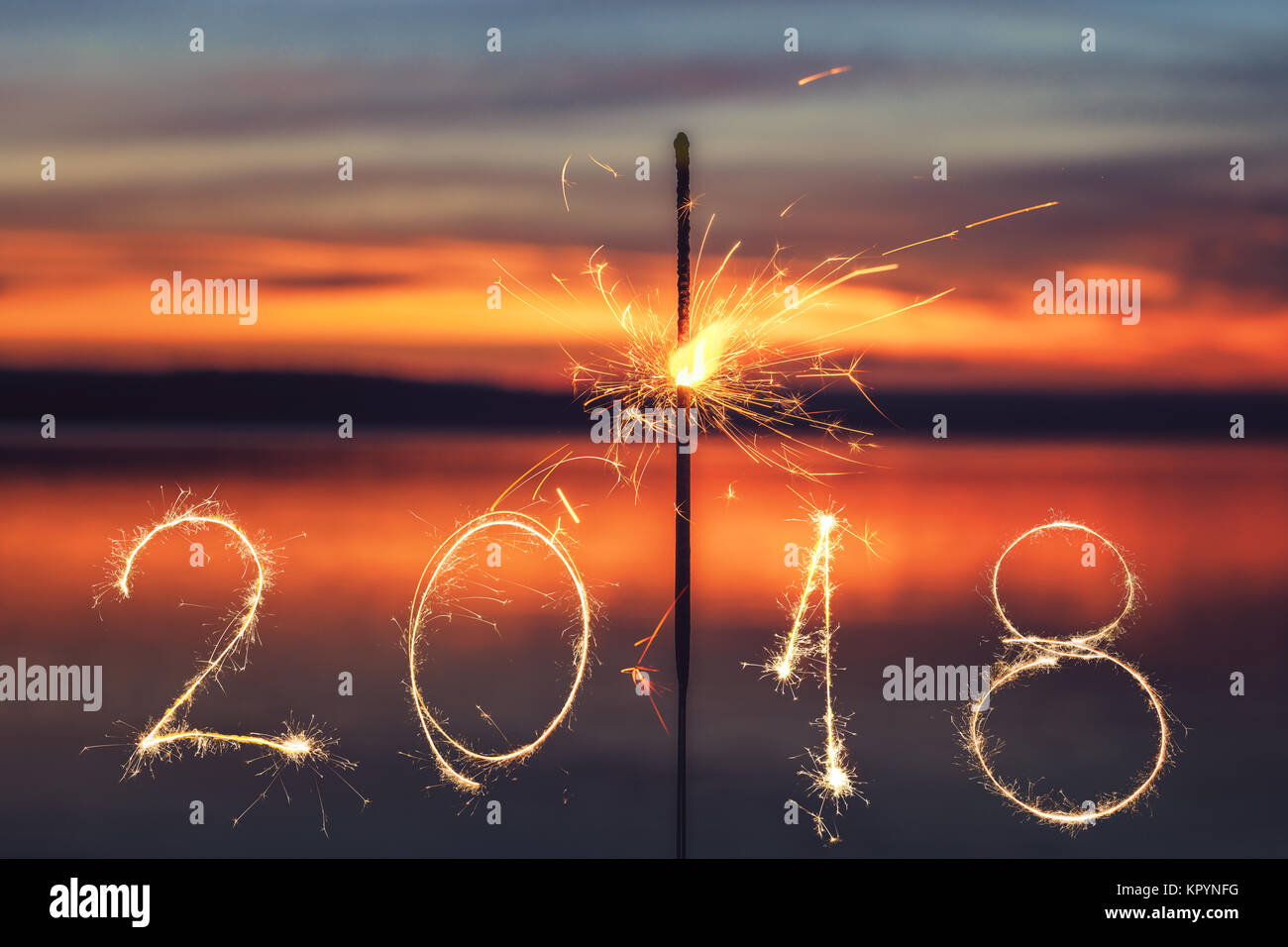 2018 written with Sparkle firework on sunset background, happy new year ...