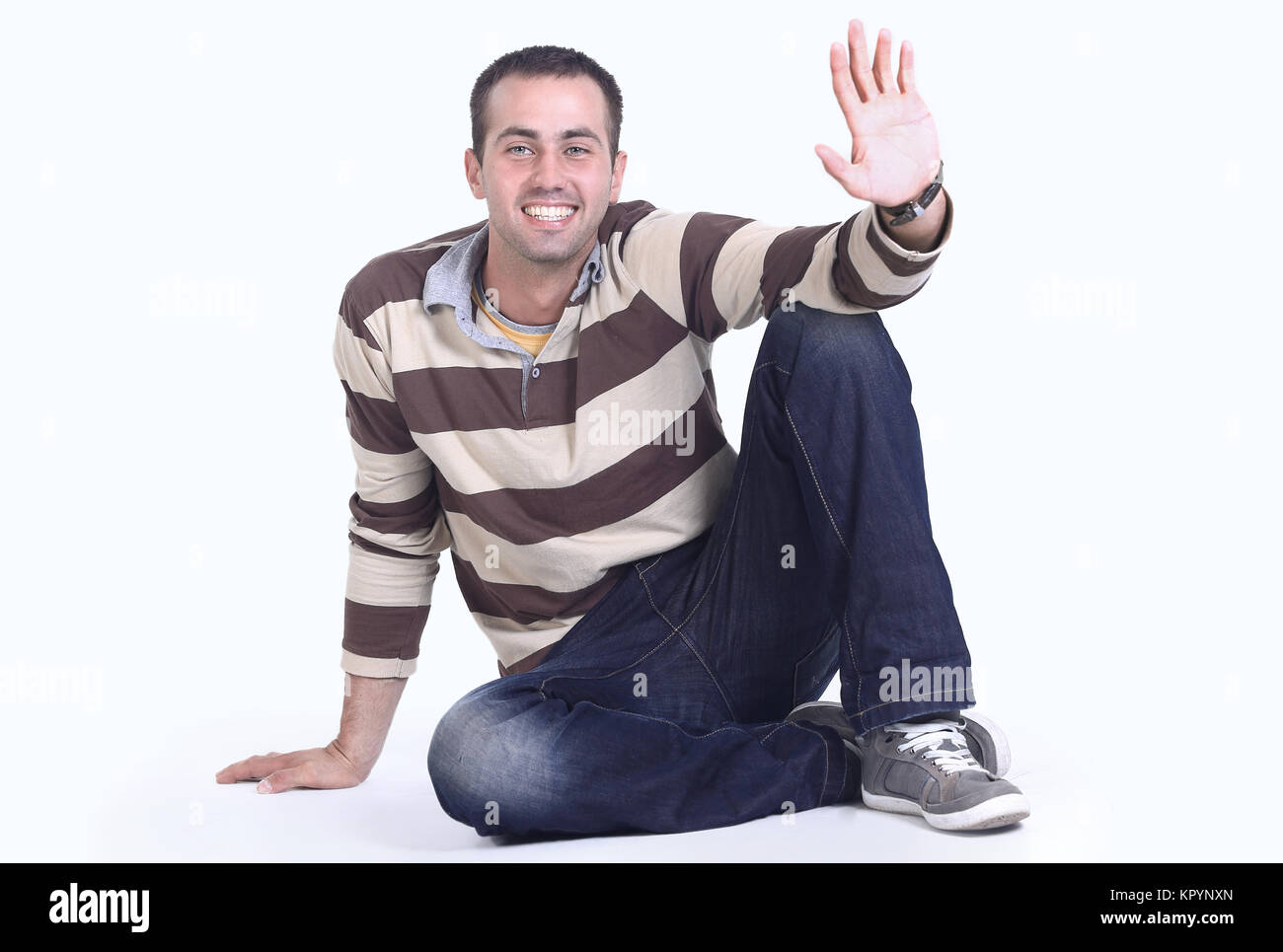 modern young man sitting on the floor Stock Photo - Alamy