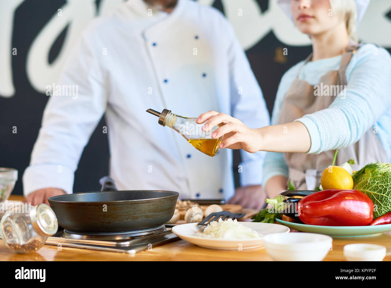 Two Cooks Adding Olive Oil to Dish Close up Stock Photo - Alamy