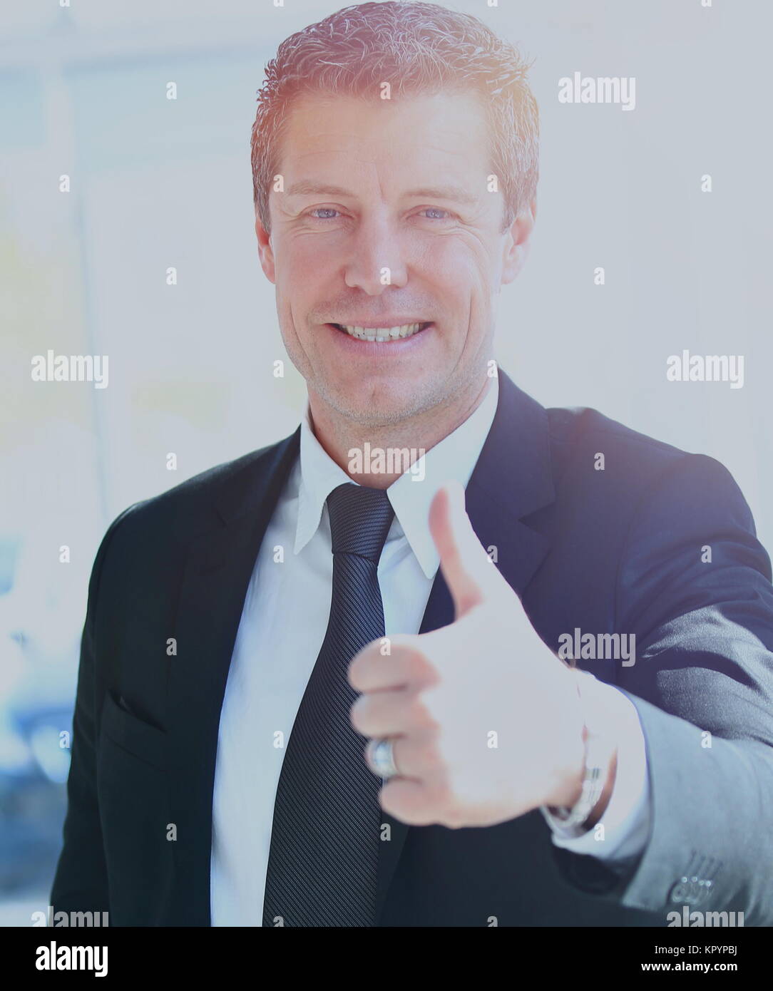 Businessman showing OK sign with his thumb up. Selective focus on face ...