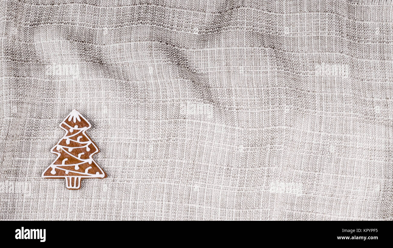 Hand-decorated Christmas gingerbread on beige crumpled fabric ...