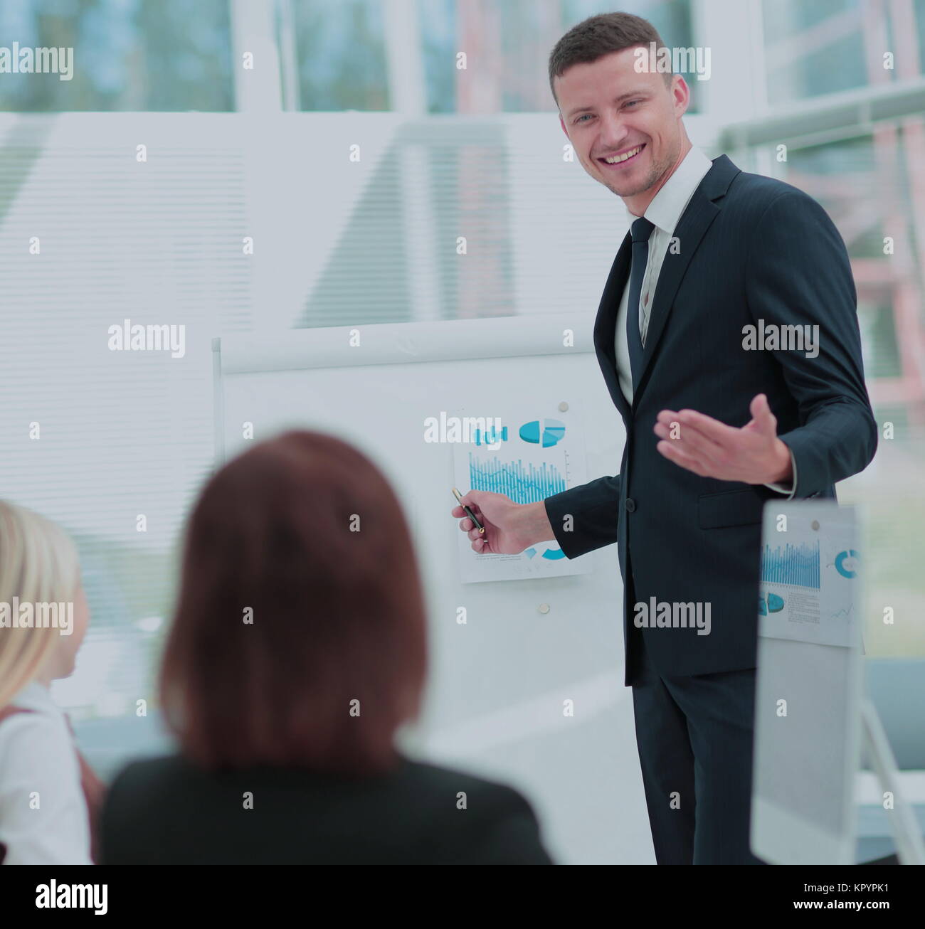 Attractive man making a business presentation to a group Stock Photo ...