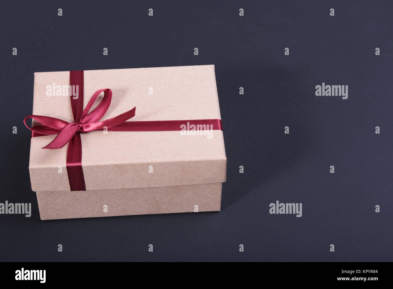 Gift boxes with bow on wood background Stock Photo - Alamy