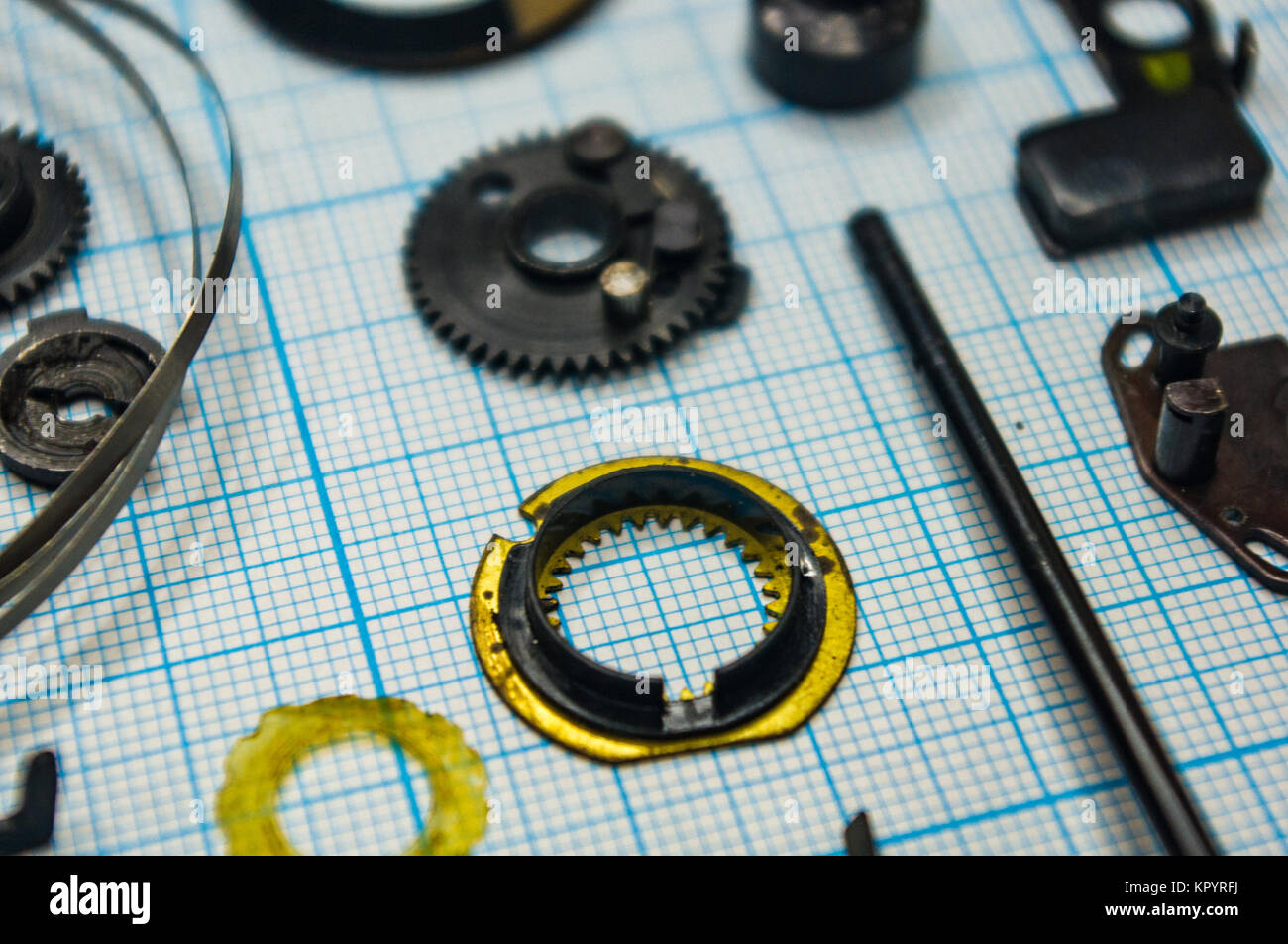 parts are completely disassembled old retro film SLR camera on graph ...