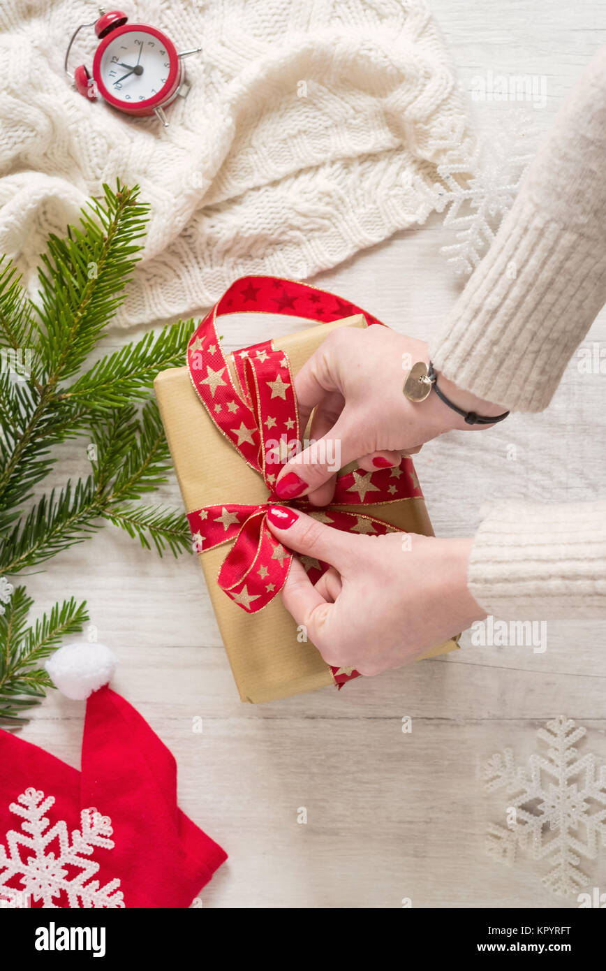 Female hands wrapping Christmas gifts Stock Photo - Alamy