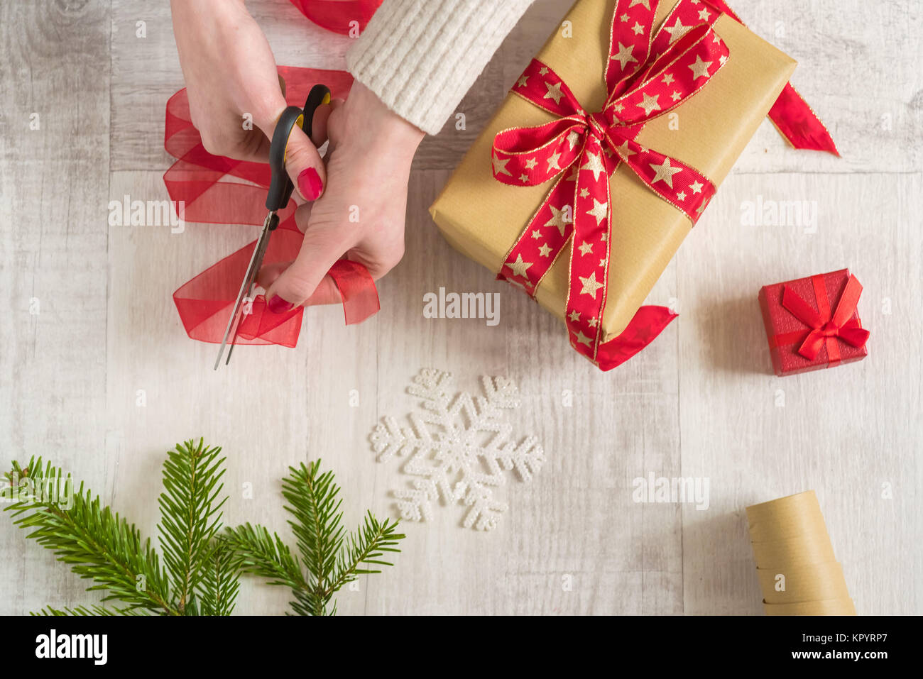 Female hands wrapping Christmas gifts Stock Photo - Alamy