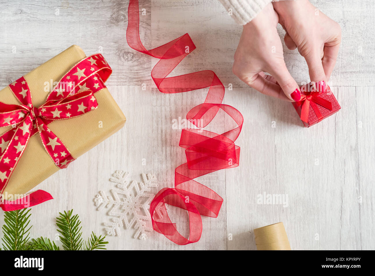 Female hands wrapping Christmas gifts Stock Photo - Alamy