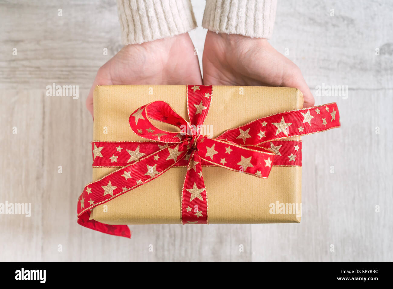 Hands holding gift box hi-res stock photography and images - Alamy