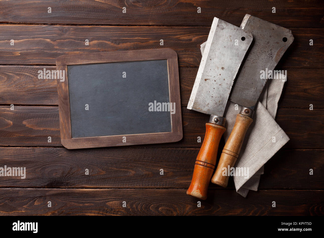 Butcher. Vintage meat knives over wooden table. Top view with space for ...