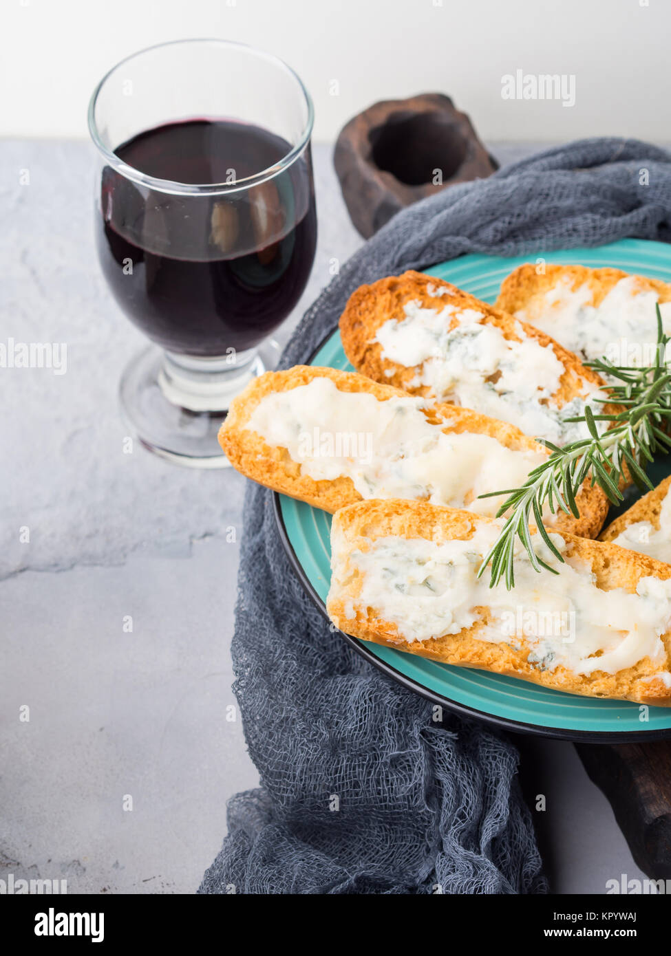 Italian toasts with gorgonzola cheese on rustic background with wine ...