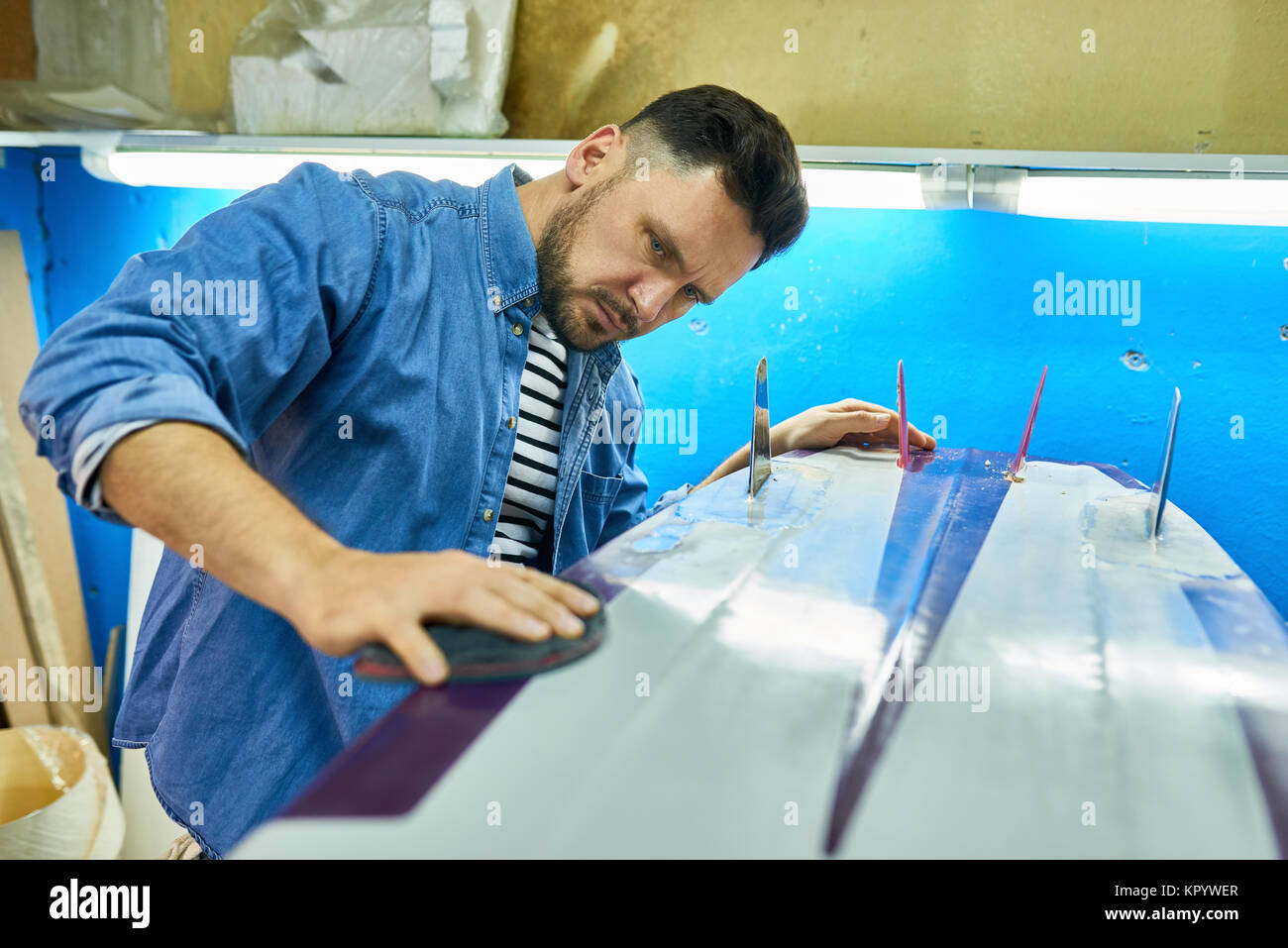 Handsome Man Polishing handmade Surfing Board Stock Photo - Alamy