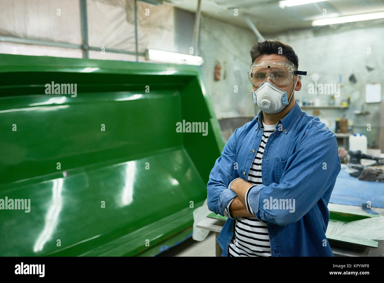 Worker Posing in Painting workshop Stock Photo - Alamy