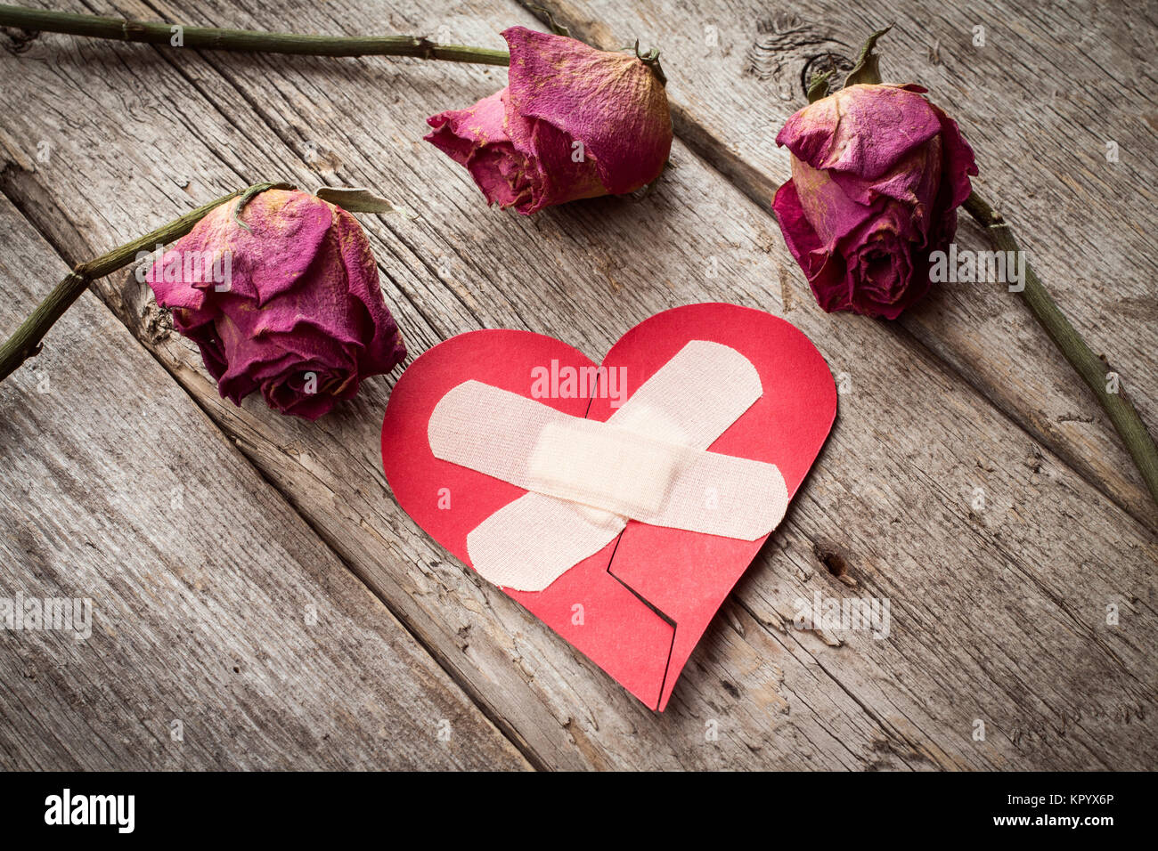Broken paper heart and old roses Stock Photo - Alamy