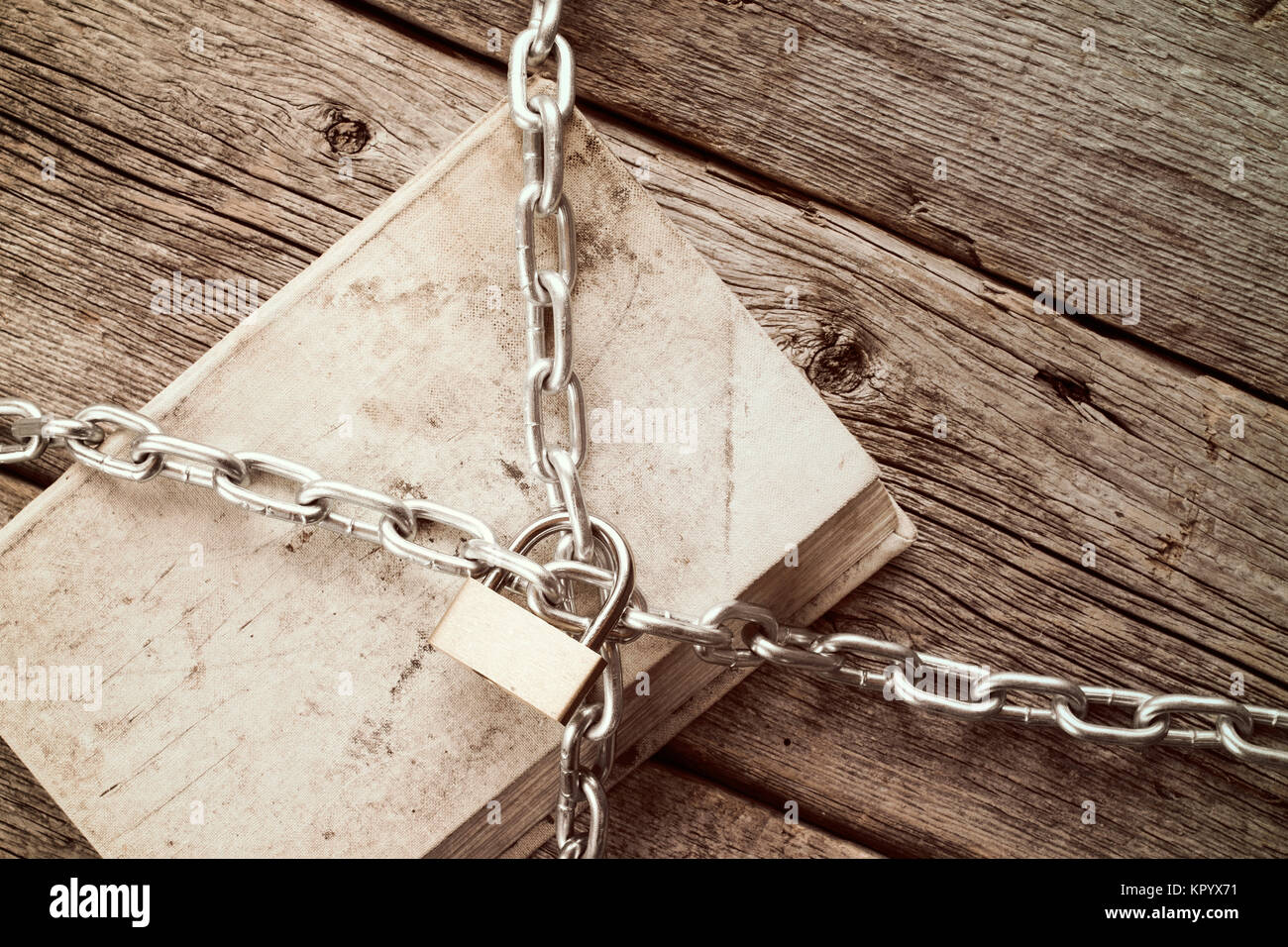 Chained book on wooden background Stock Photo - Alamy