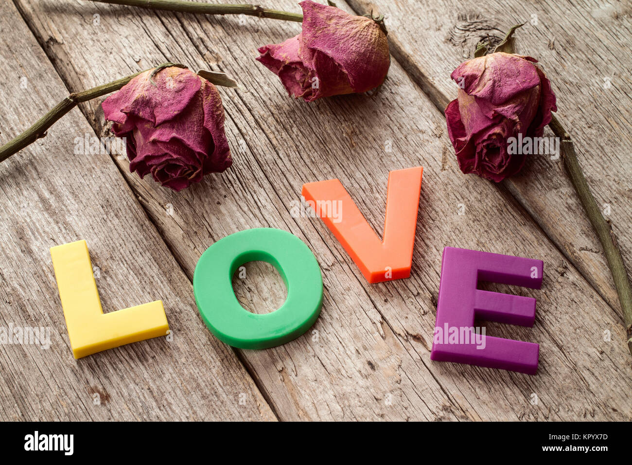 Dry roses with word LOVE Stock Photo - Alamy